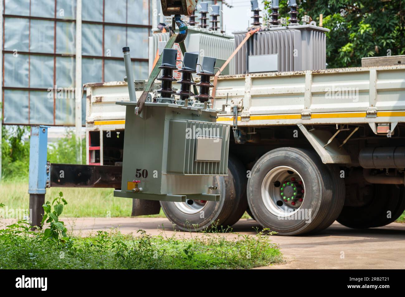 crane hook lifts up the distribution transformer Stock Photo - Alamy