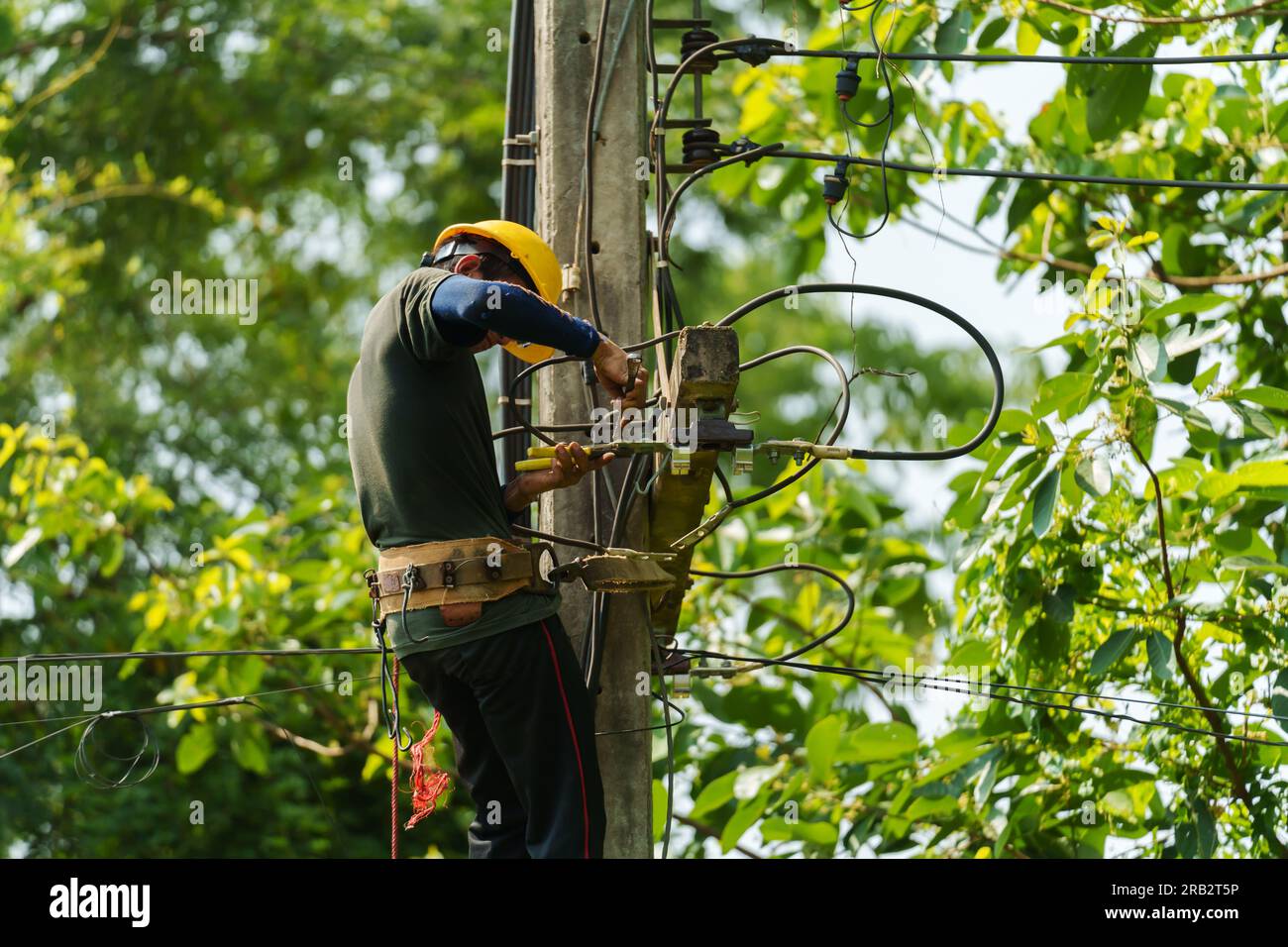 technician climbing the electric poles and connecting wires Stock Photo ...