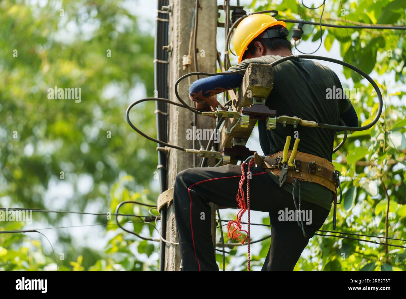 technician climbing the electric poles and connecting wires Stock Photo ...