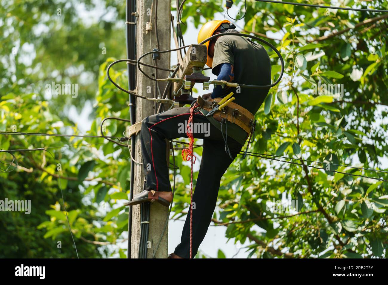 technician climbing the electric poles and connecting wires Stock Photo ...
