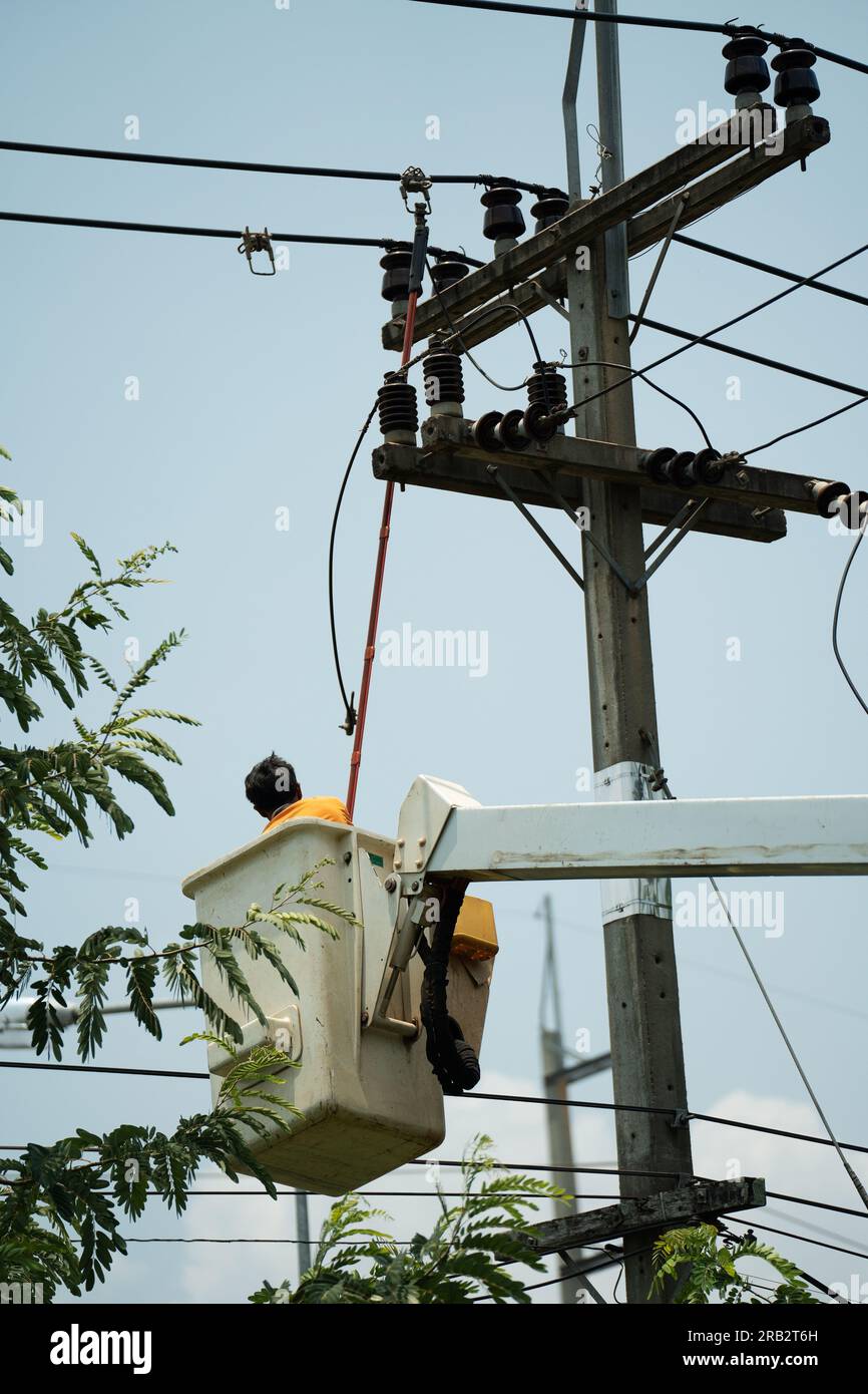 electrician using clamp stick (insulated tool) to restore power on the ...