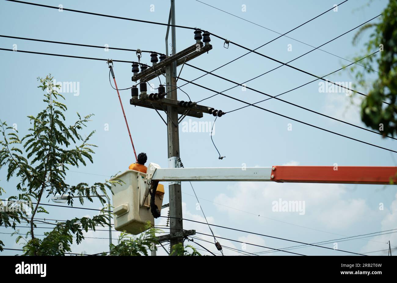 electrician using clamp stick (insulated tool) to restore power on the ...