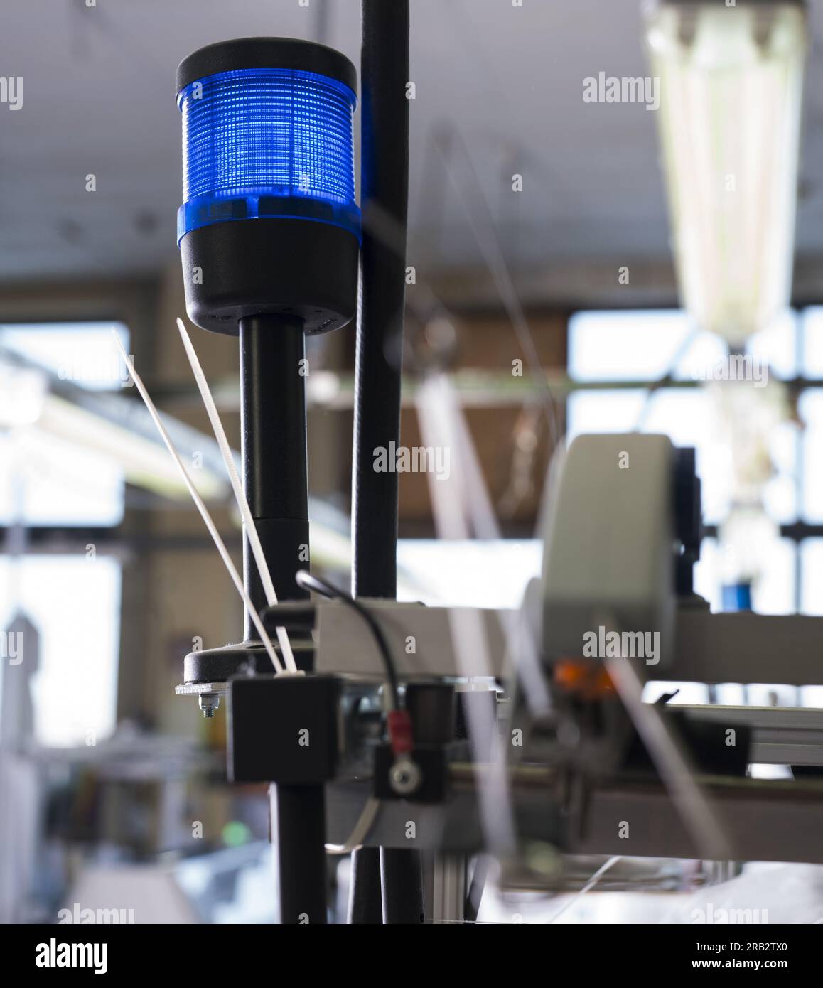 Knitting machine blue signal lamp shot Stock Photo - Alamy
