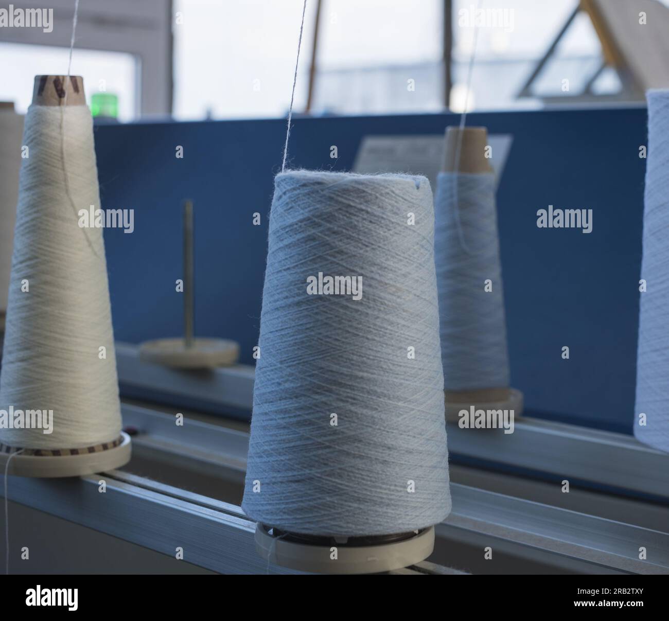 Spools with white thread at knitting shop view Stock Photo - Alamy