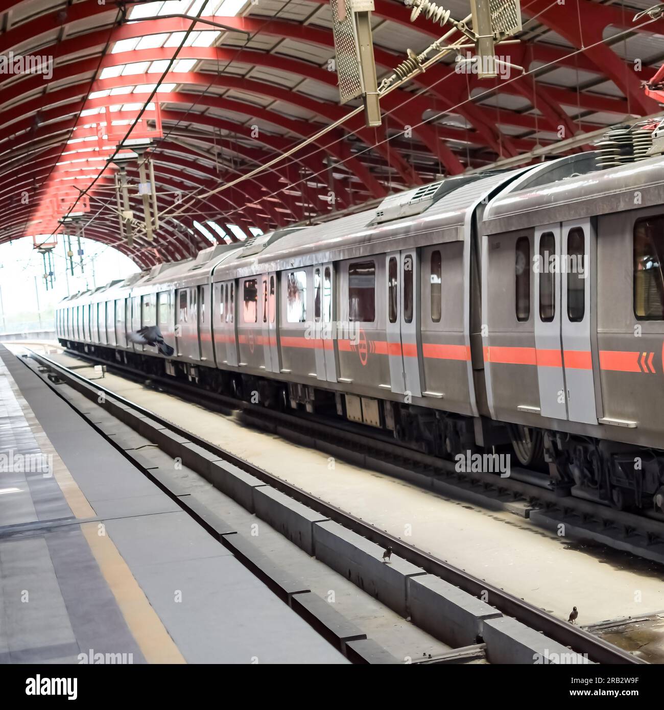 Delhi Metro train arriving at Jhandewalan metro station in New Delhi ...
