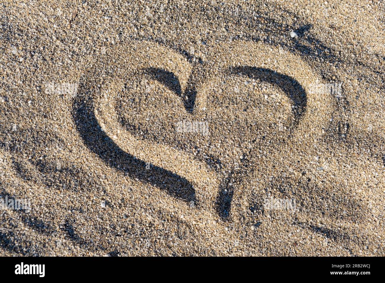 Heart shape and footprint on wet sand Stock Photo - Alamy