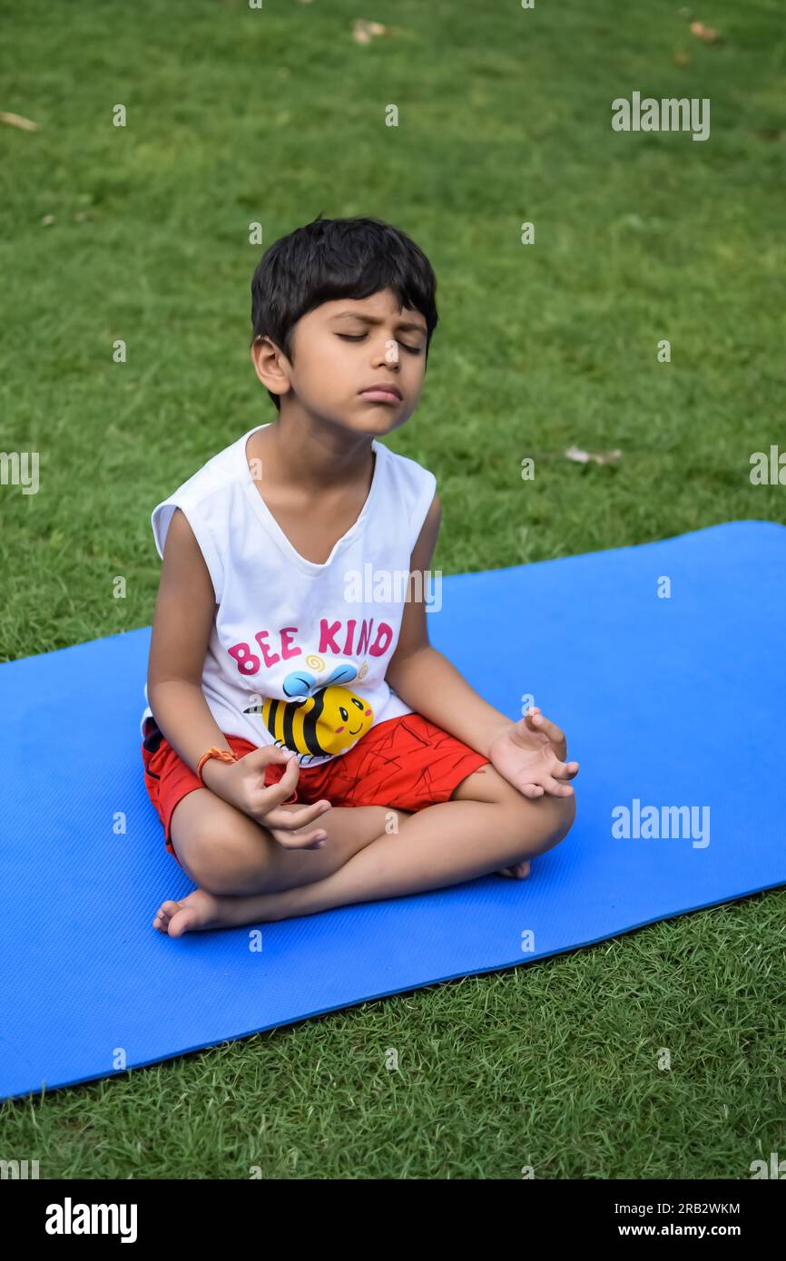 Asian smart kid doing yoga pose in the society park outdoor, Children's ...