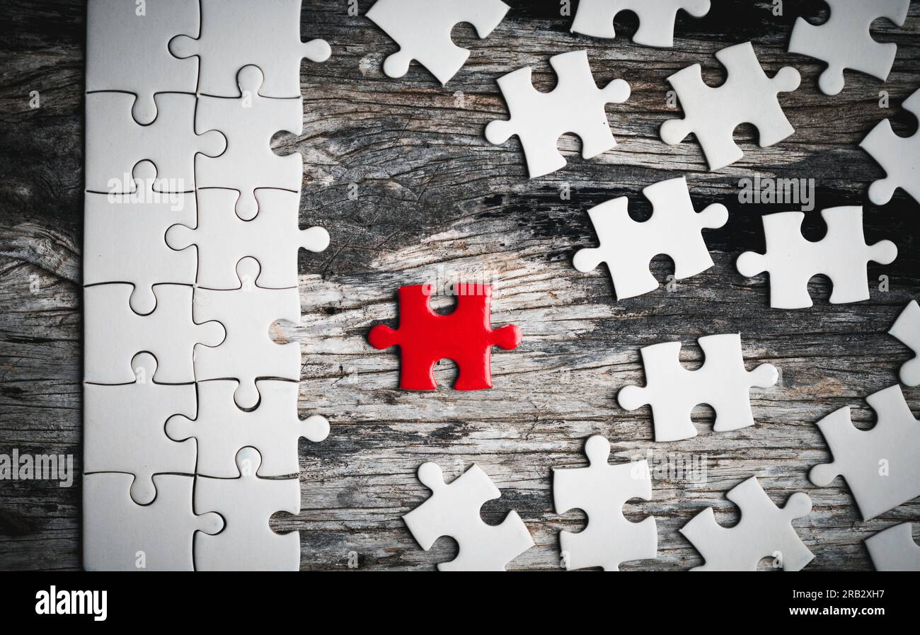 White details of jigsaw puzzle piece on wooden background. Concept of ...