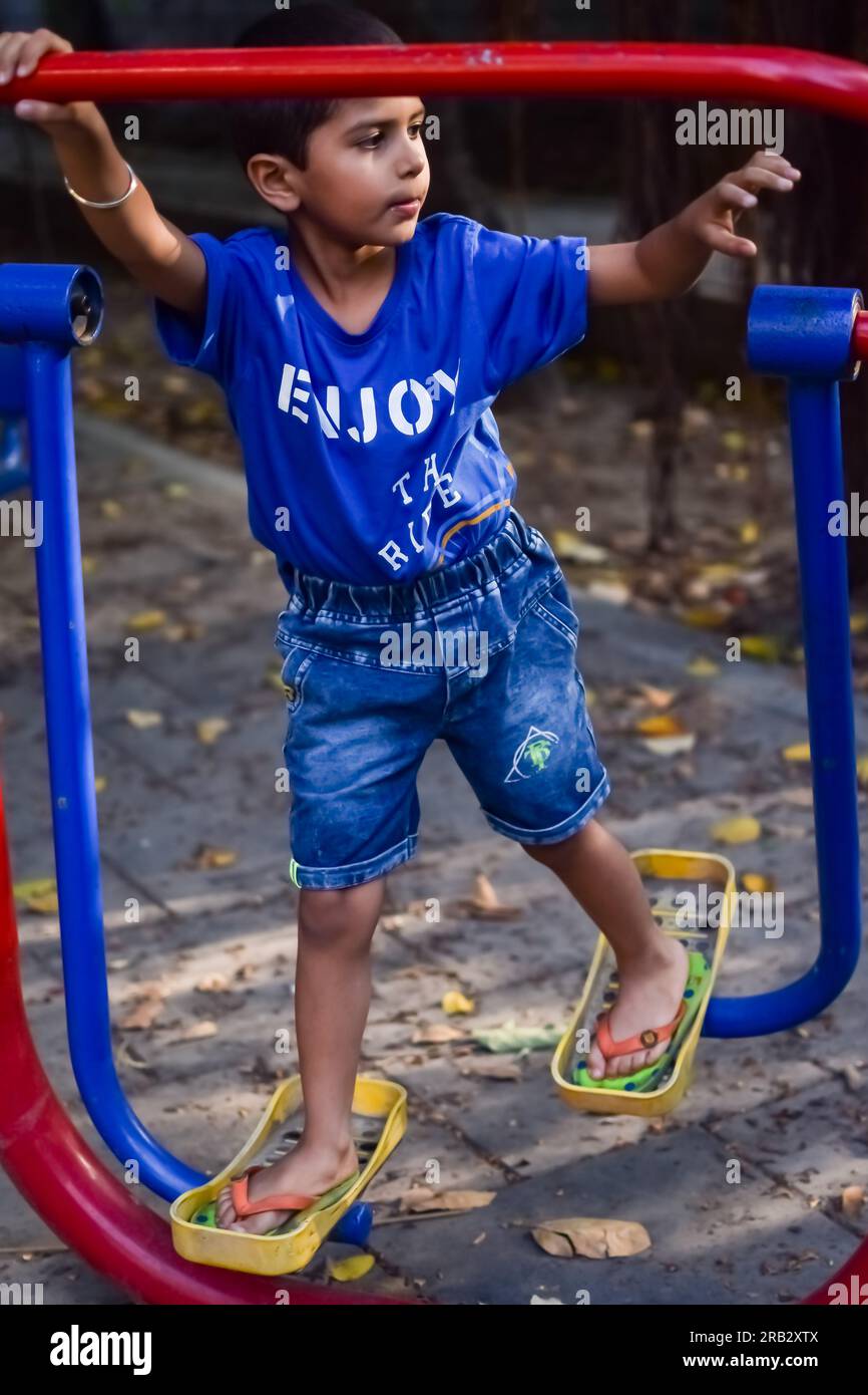 Asian boy doing routine exercise in society park during the morning ...