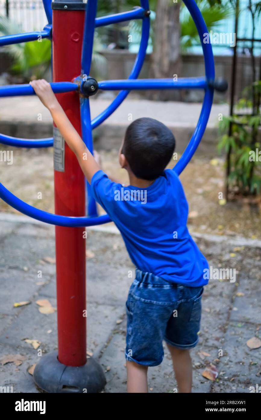 Asian boy doing routine exercise in society park during the morning ...