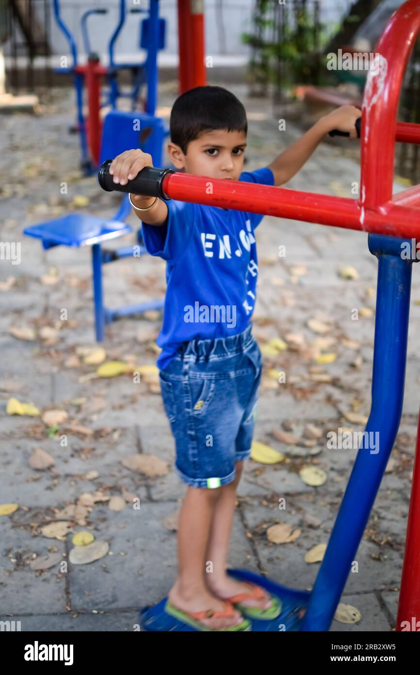 Asian boy doing routine exercise in society park during the morning ...