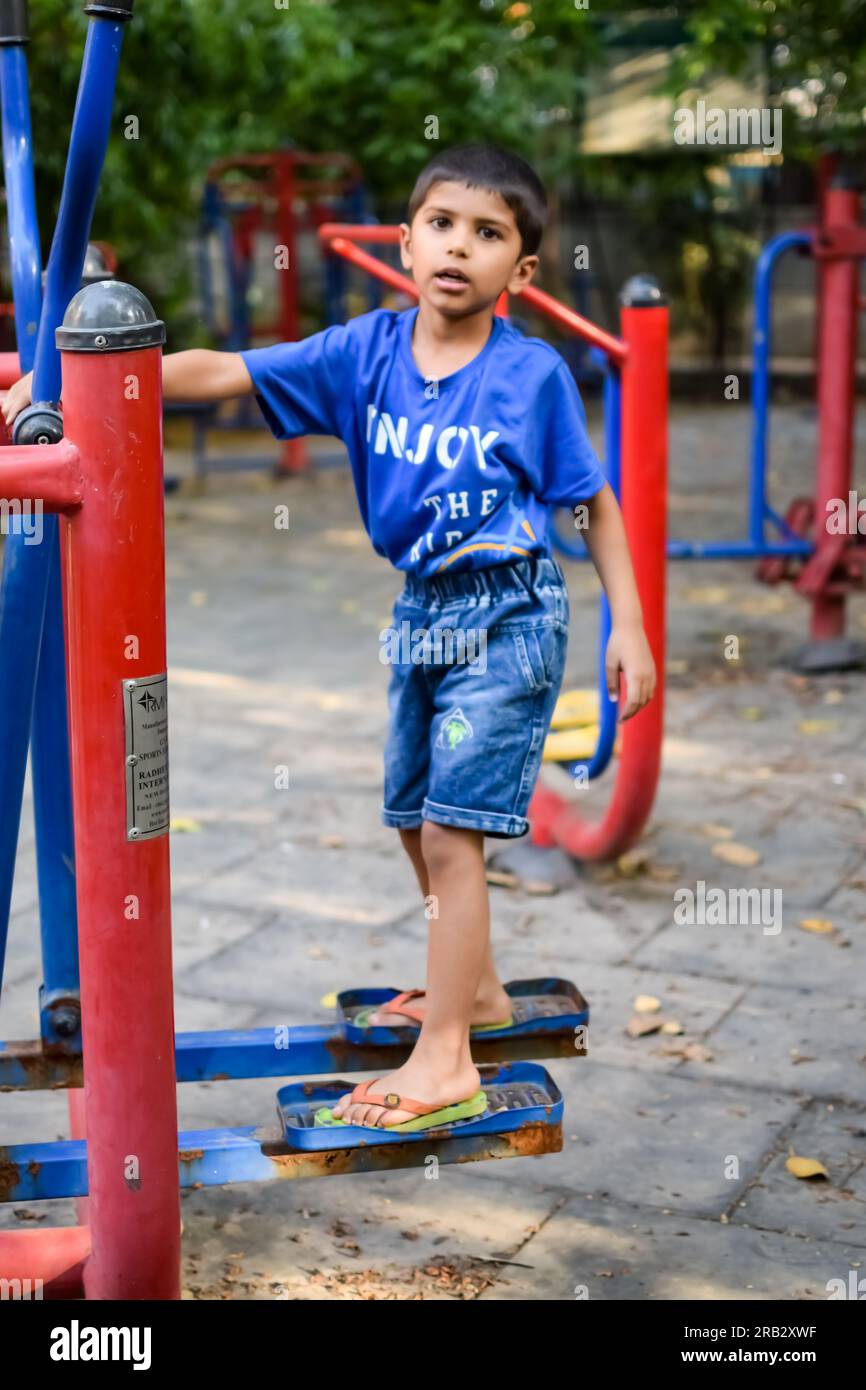 Asian boy doing routine exercise in society park during the morning ...