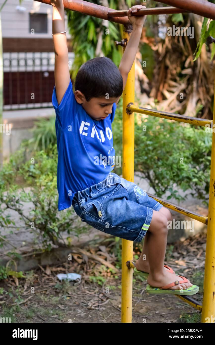 Asian boy doing routine exercise in society park during the morning ...