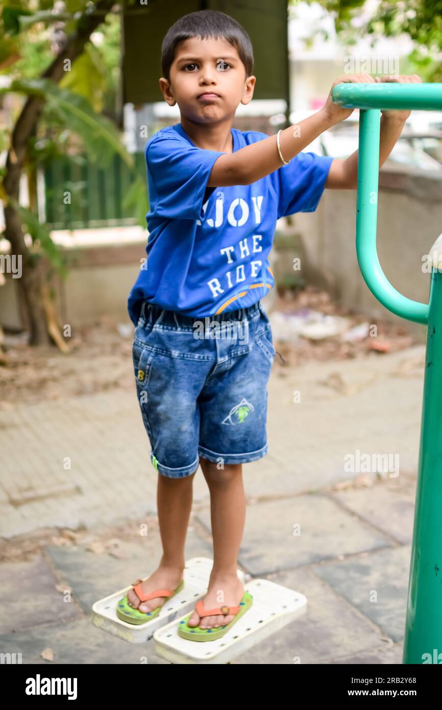 Asian boy doing routine exercise in society park during the morning ...
