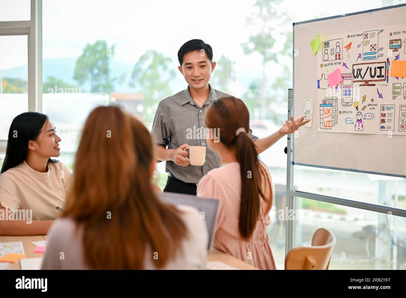 A professional Asian male tech developer is presenting his project to ...