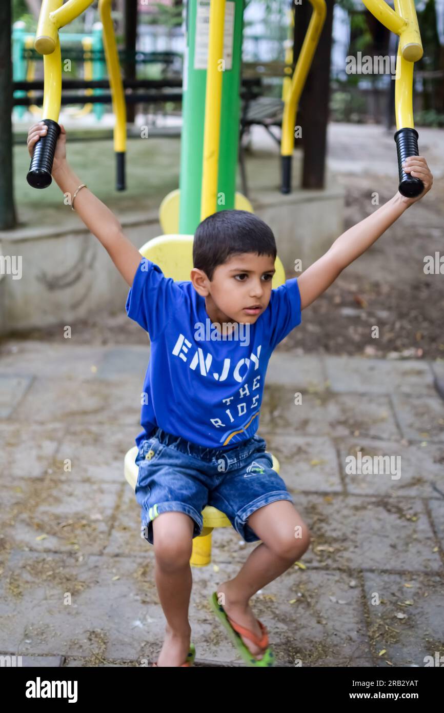 Asian boy doing routine exercise in society park during the morning ...