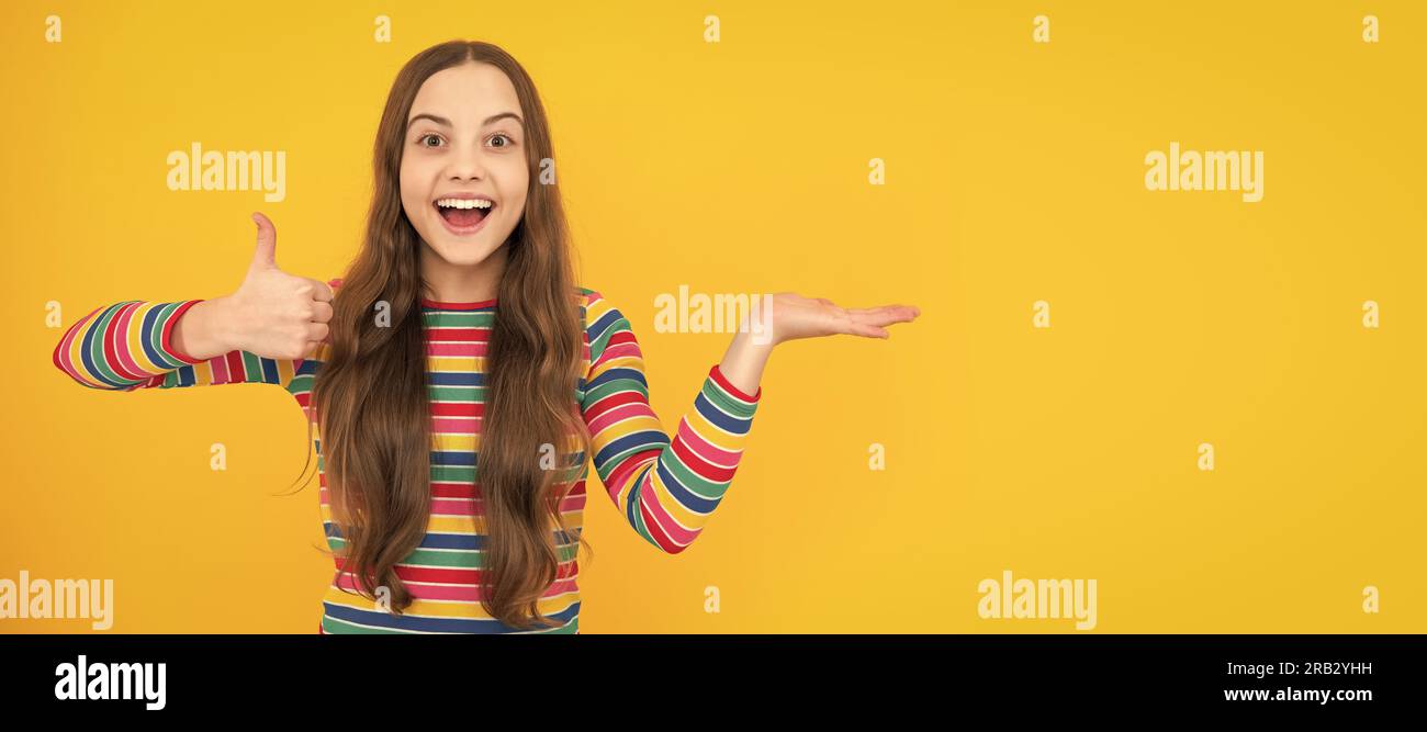 Impressed teenage girl showing recommendation copyspace. Child face ...
