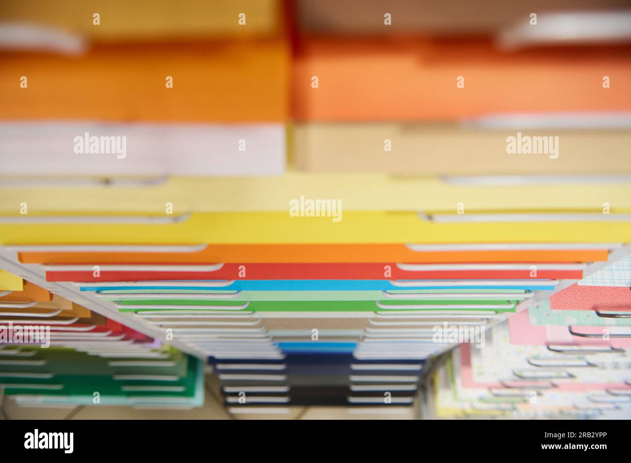 View from above of color vibrant paper arranged on shelves, display for ...
