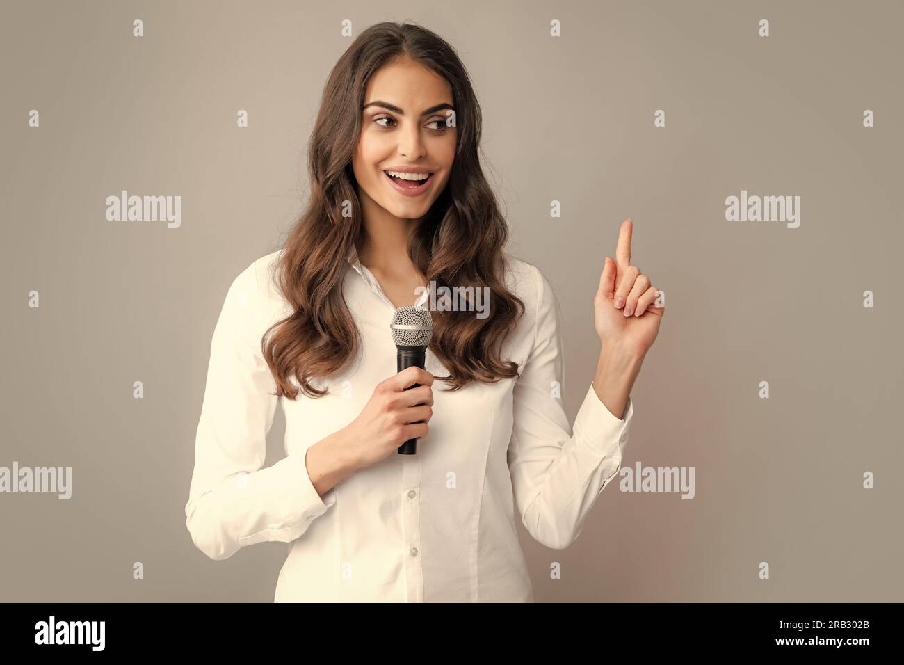Woman speech, business woman holding a microphone. Young woman talking ...