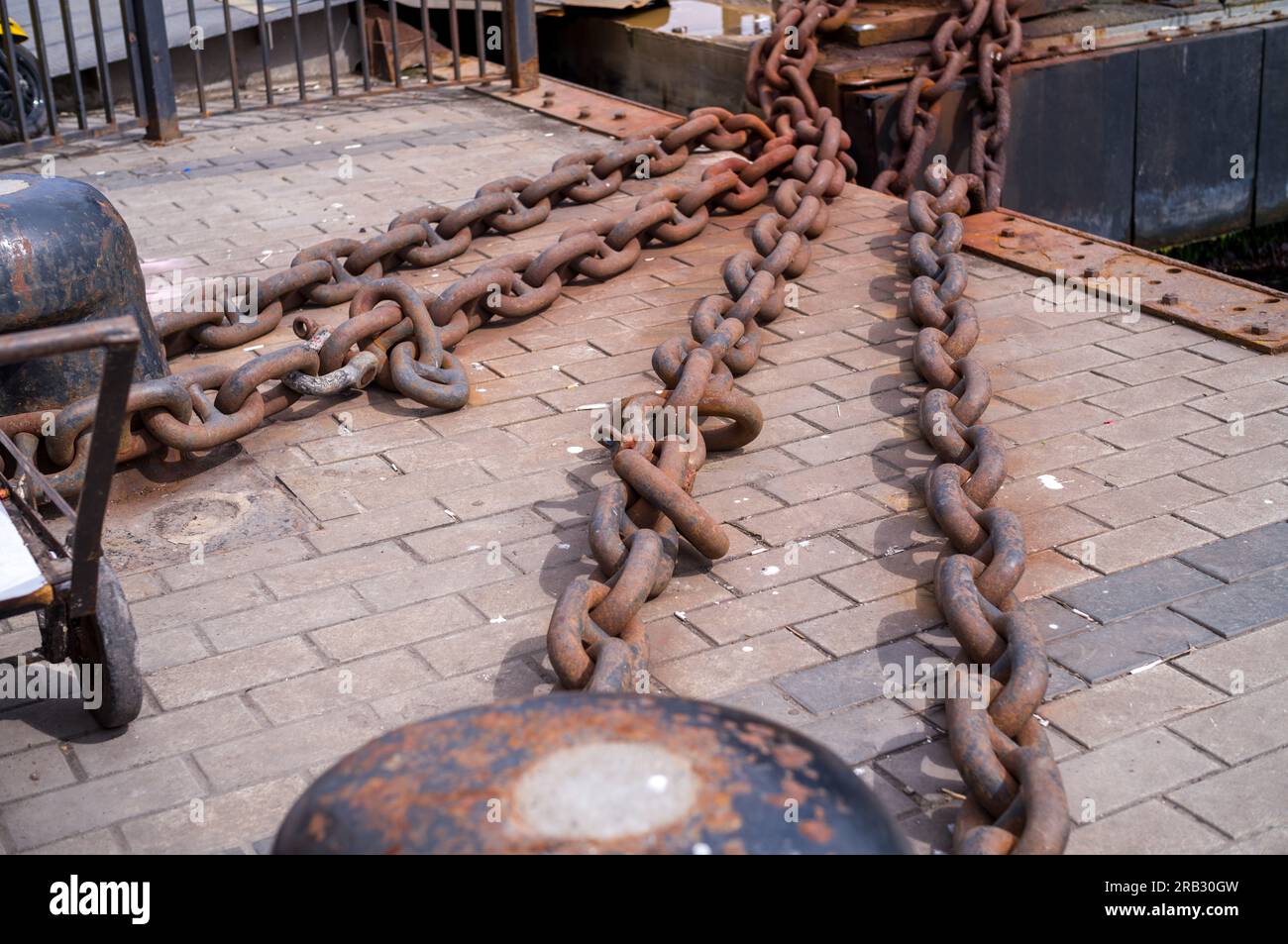 heavy rusty iron chains are placed around a bollard Stock Photo - Alamy