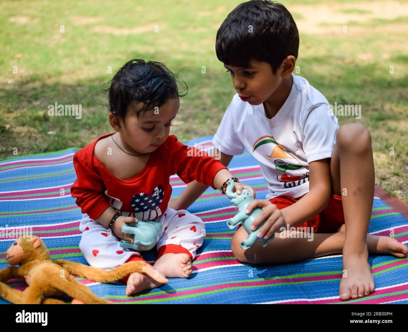 Two happy boys in society park, happy Asian brothers who are smiling ...