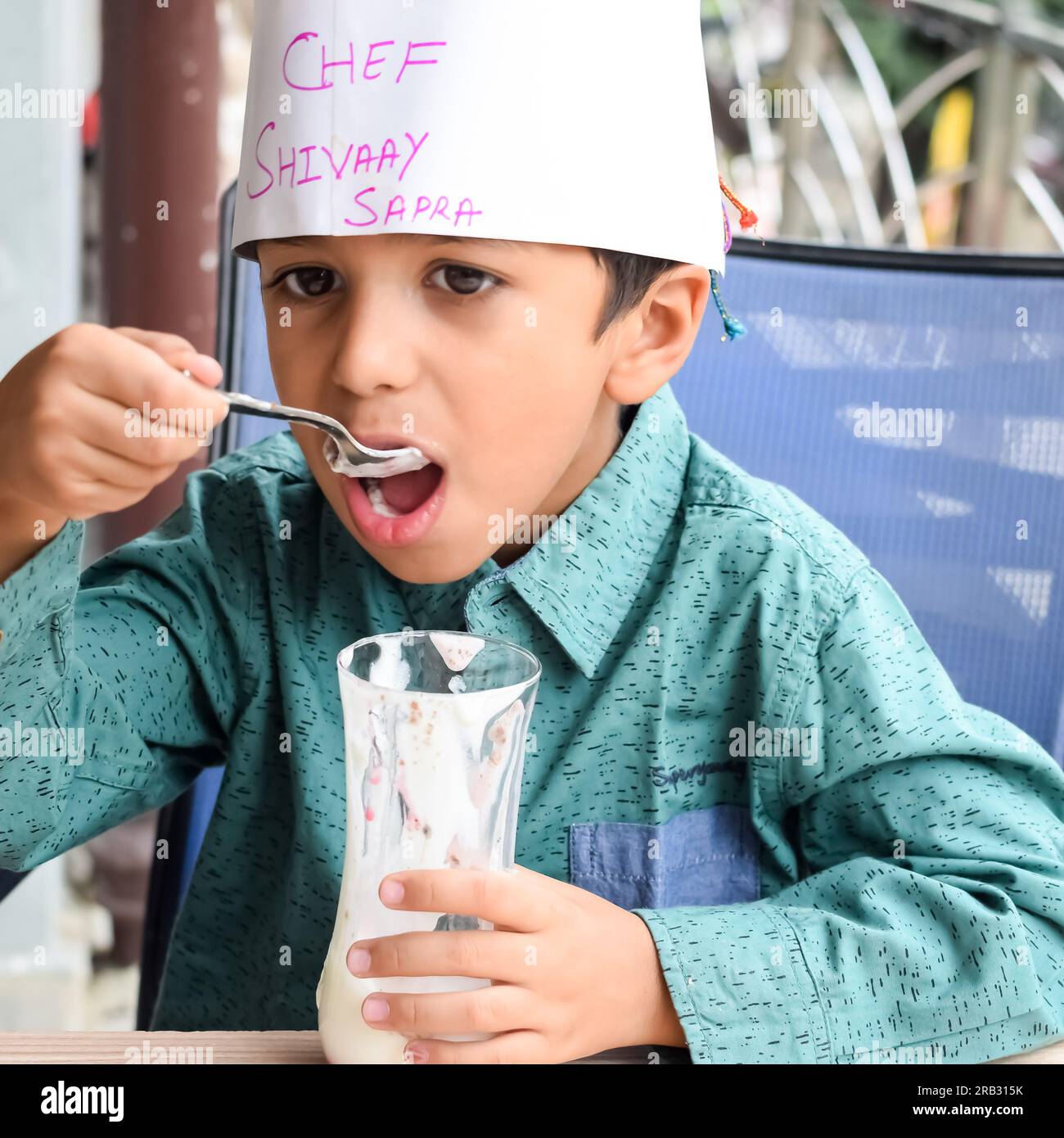 Cute Indian chef boy preparing sundae dish as a part of non fire ...