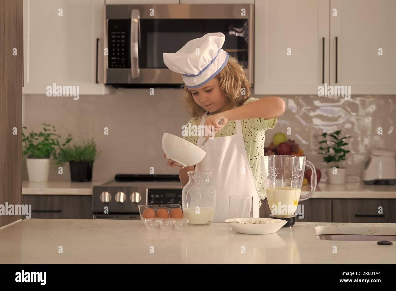 Funny kid chef cook cookery at kitchen. Chef kid boy making healthy ...