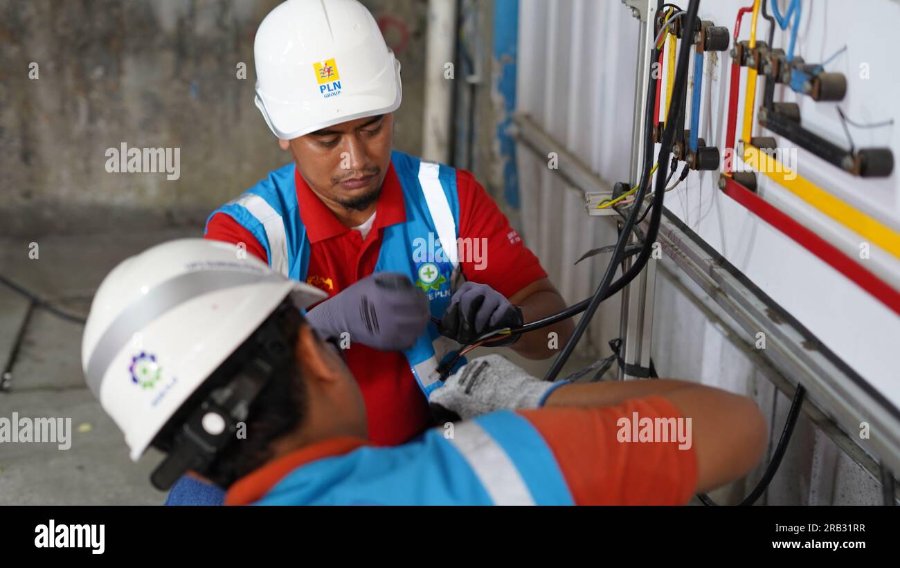 PLN officers are repairing damaged electricity Stock Photo - Alamy