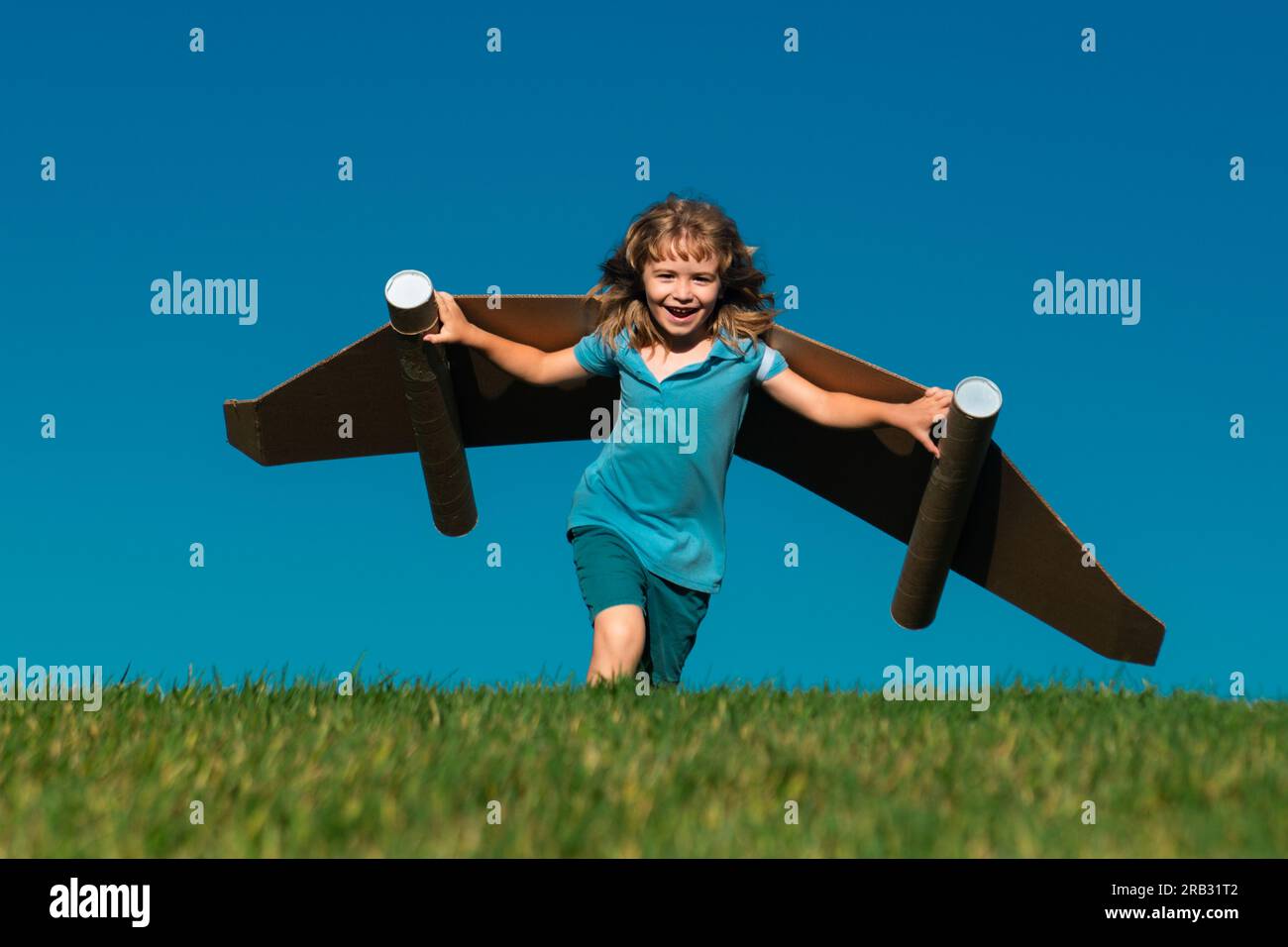 Child run with paper wings against blue sky. Kid dreams of future. Kid ...
