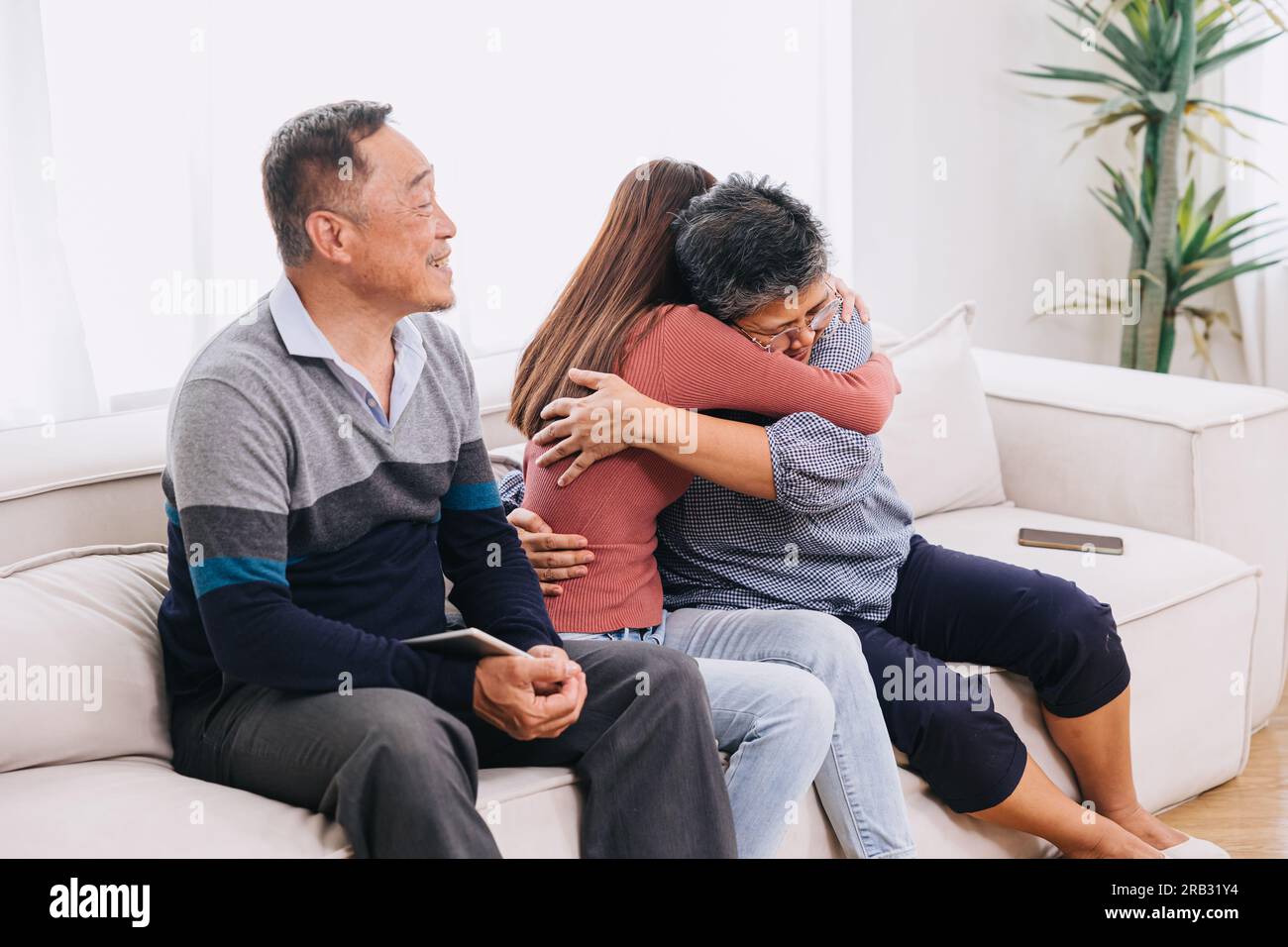 teen girl daughter hug embrace mother sitting with parent at home for ...