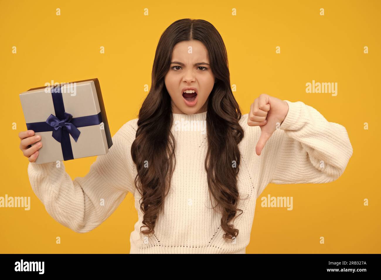 Angry face, upset emotions of teenager girl. Child teen girl with gift ...