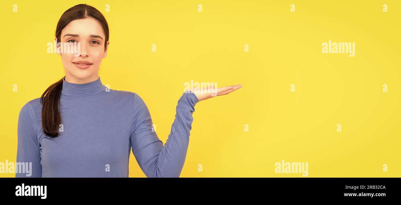 portrait of lady on yellow background. advertisement. woman presenting ...
