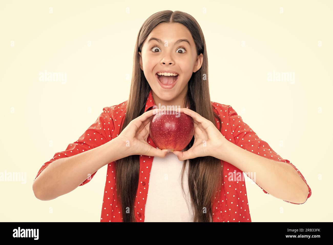 Child girl eating an apple over isolated white background. Tennager ...
