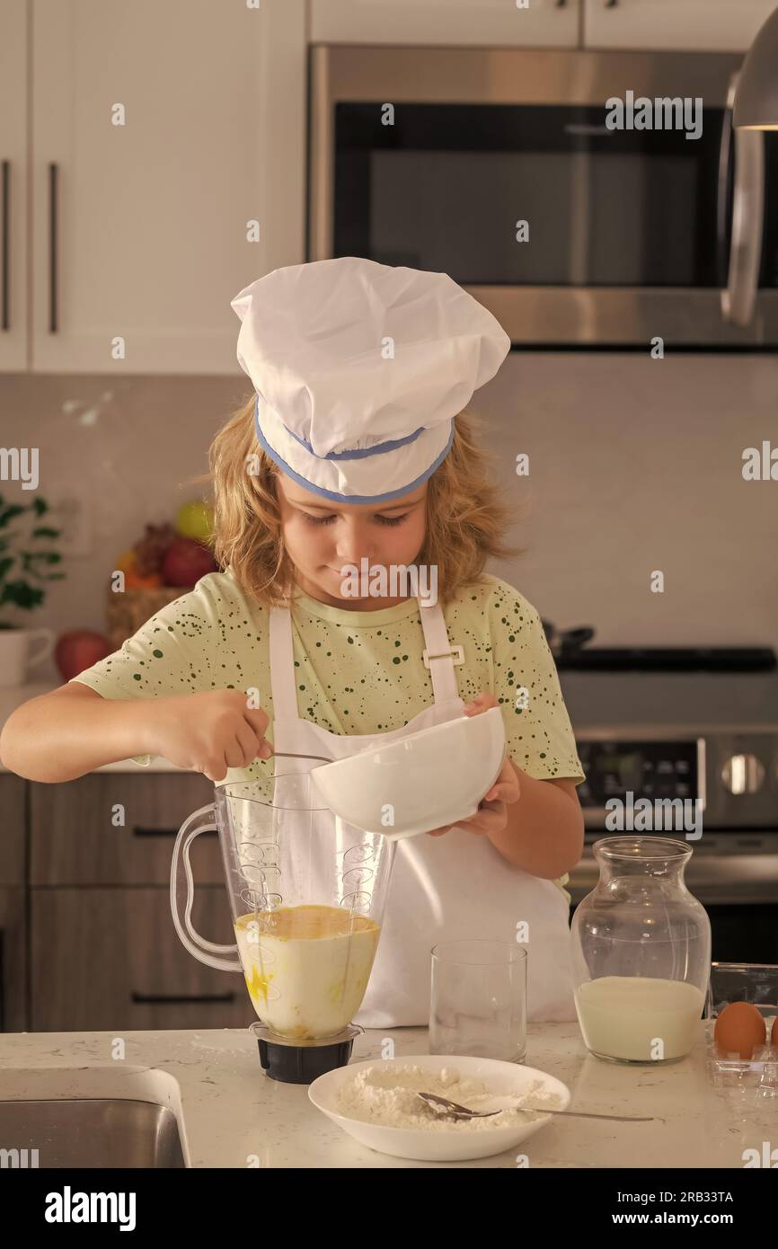 Children cooking in the kitchen. Funny kid chef cook cookery at kitchen ...