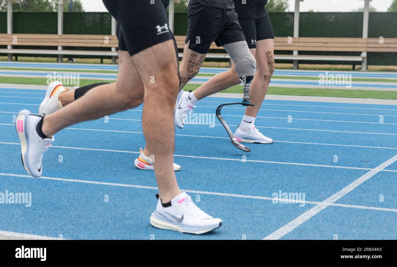 An athlete with a prosthetic leg is seen running in a group on a ...