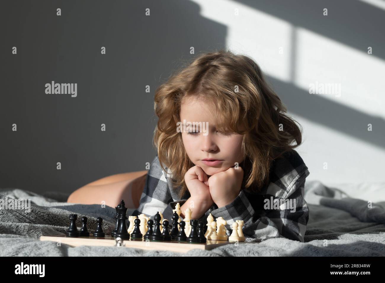 Chess game with kids at home. Kid playing chess. Child thinking near ...
