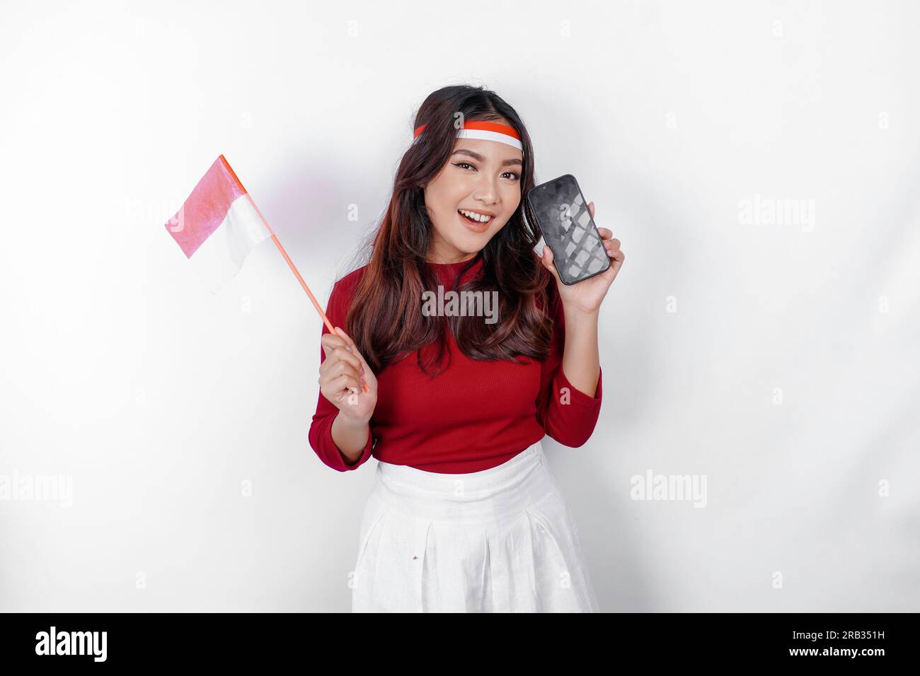 A Happy Asian Woman Wearing Headband Holding Her Phone And Indonesian
