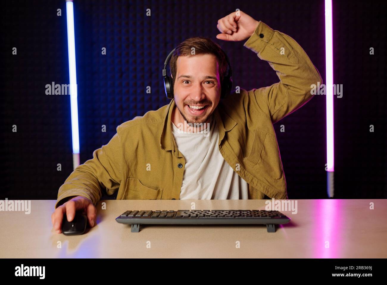 Emotional young gamer rejoices in winning a video game with a smile on ...