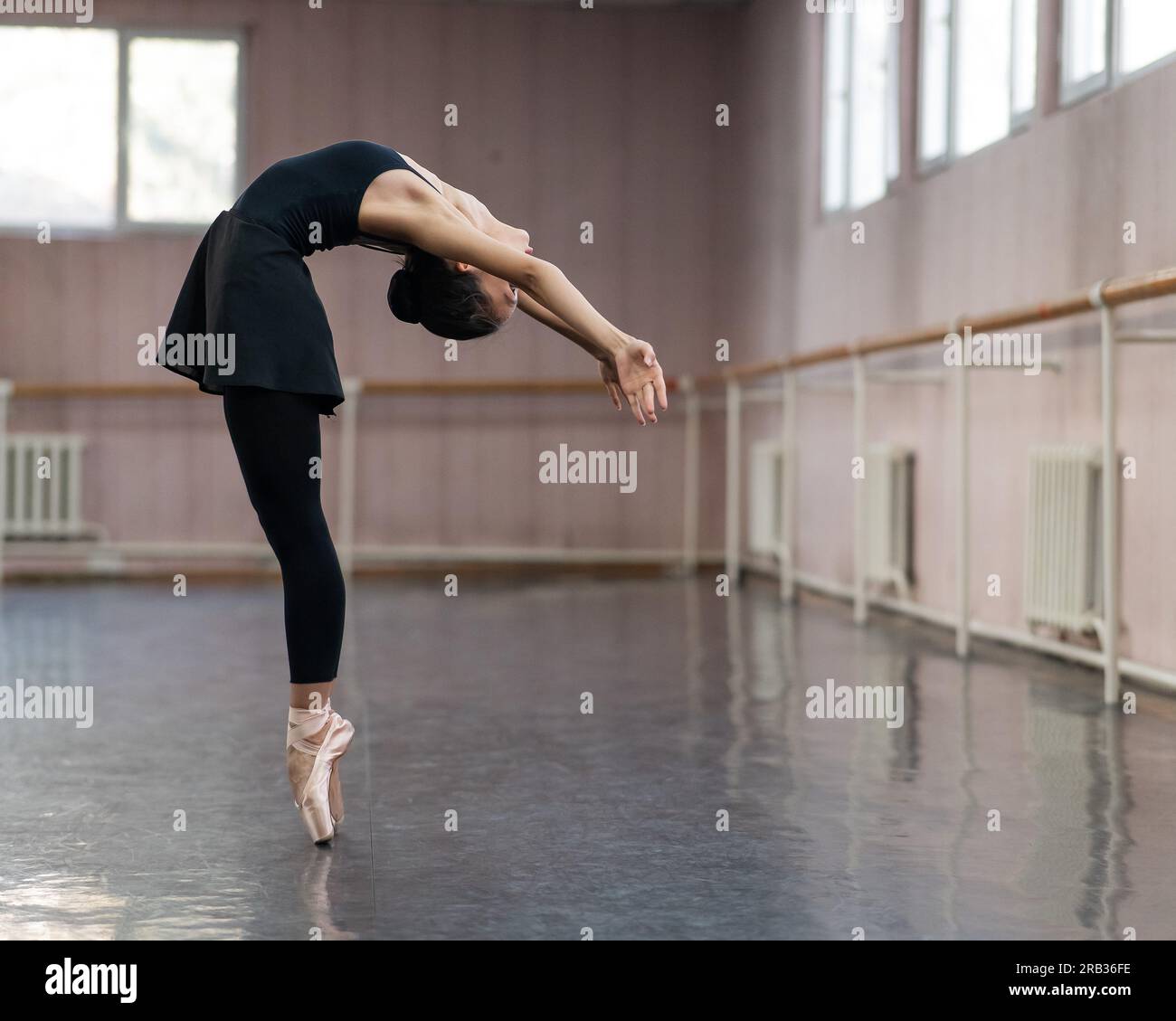 Asian woman dancing in ballet class. Bending in the back Stock Photo ...