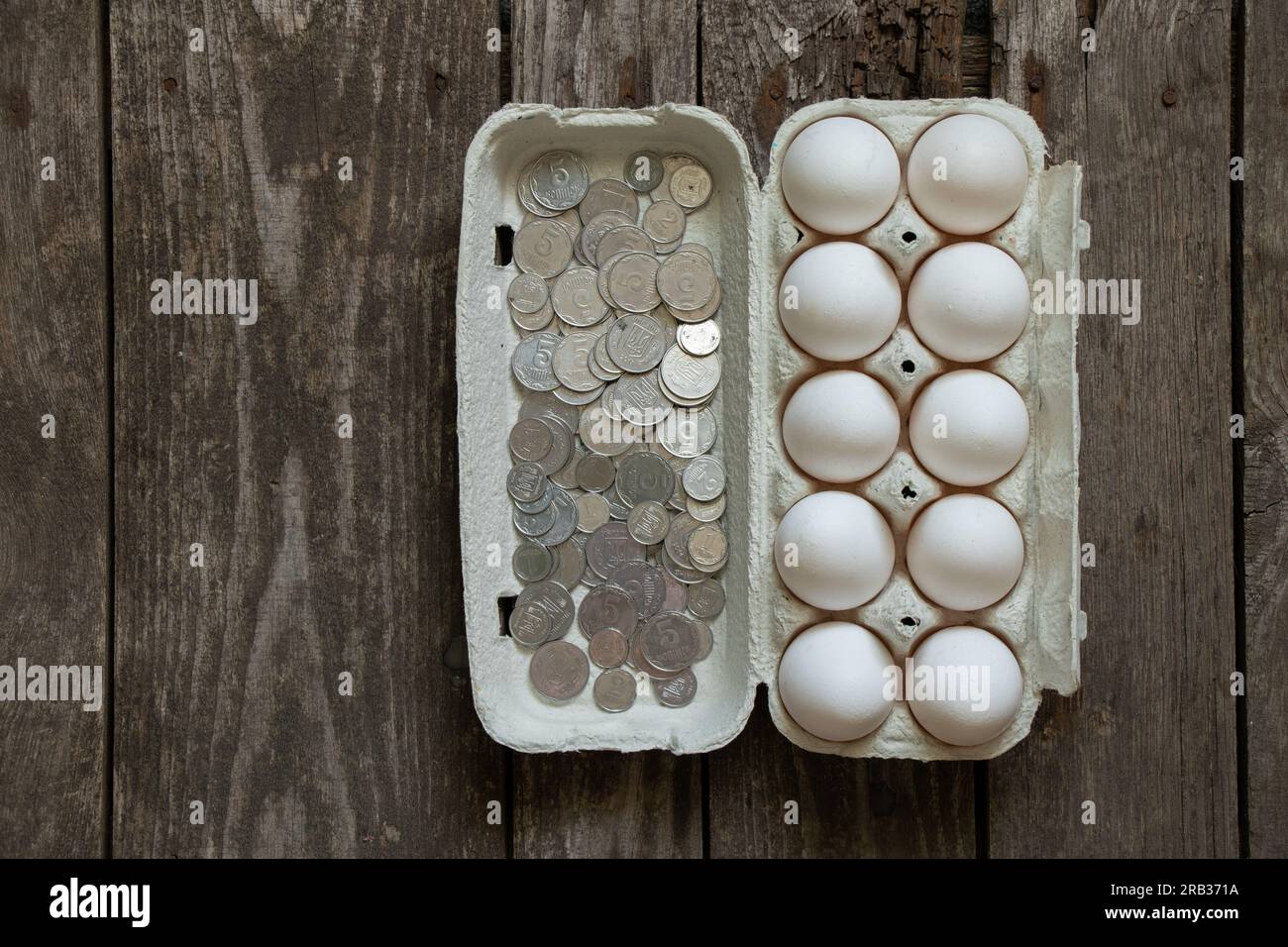 Chicken eggs in packaging and Ukrainian penny money on an isolated ...