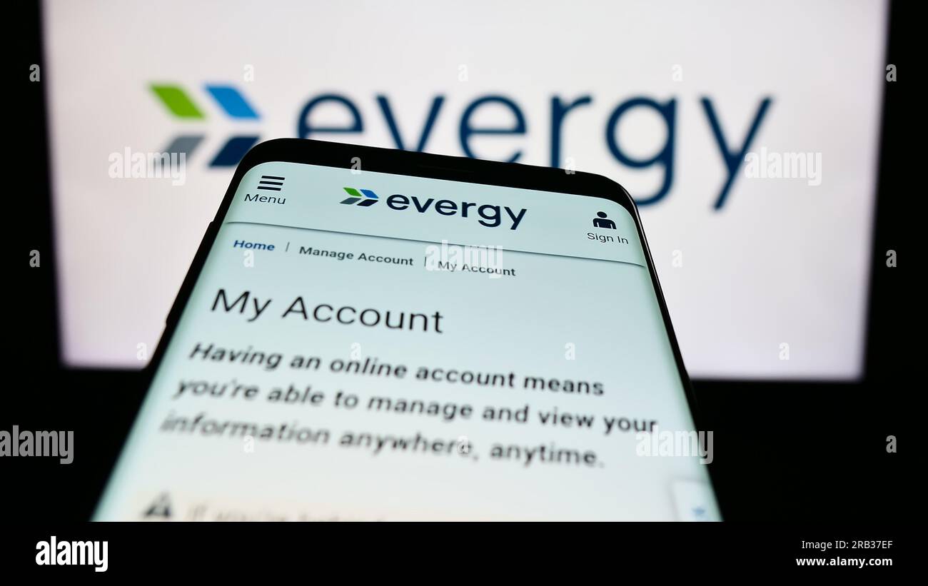 Smartphone with webpage of US utility company Evergy Inc. on screen in ...