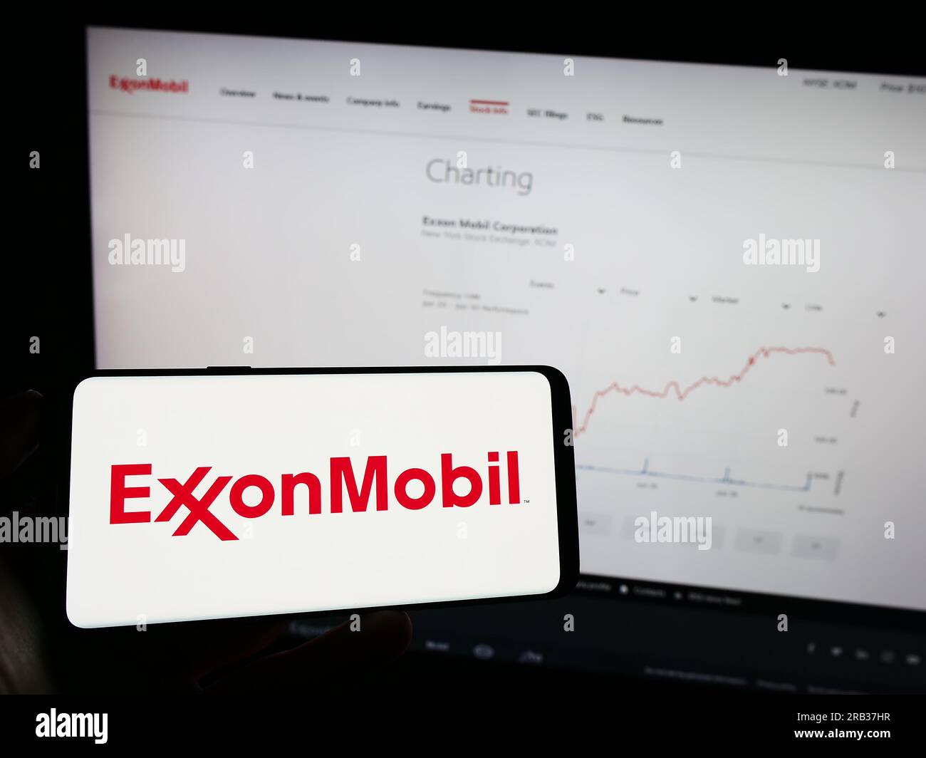 Person holding mobile phone with logo of US petroleum company Exxon ...