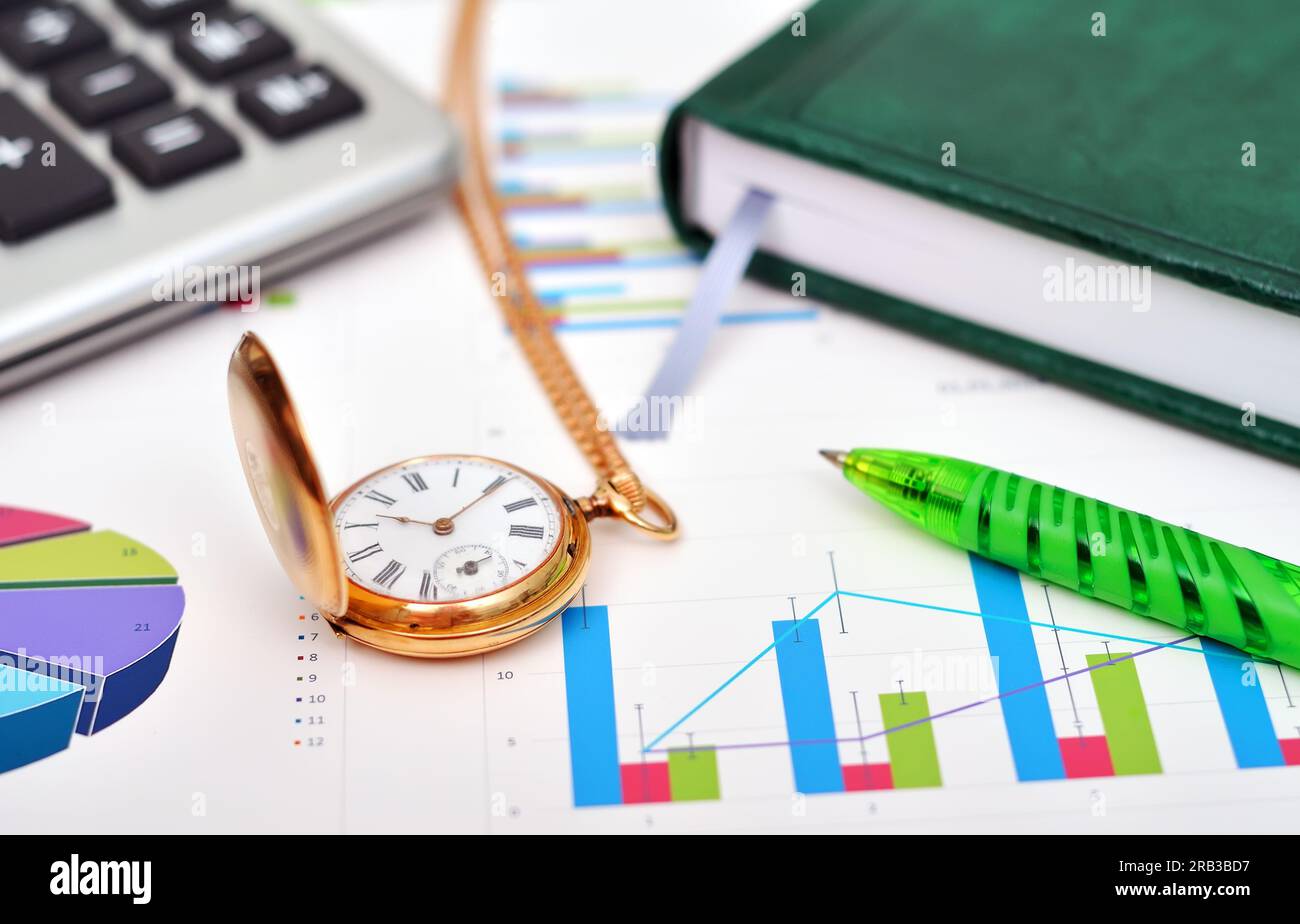 business charts, pen and gold pocket watch Stock Photo - Alamy