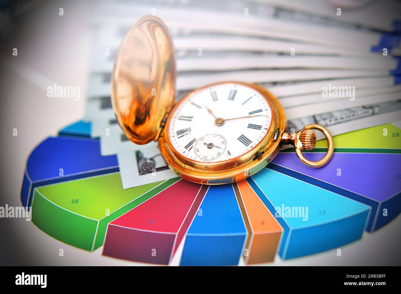 business pie charts and antique gold pocket watch on table Stock Photo ...