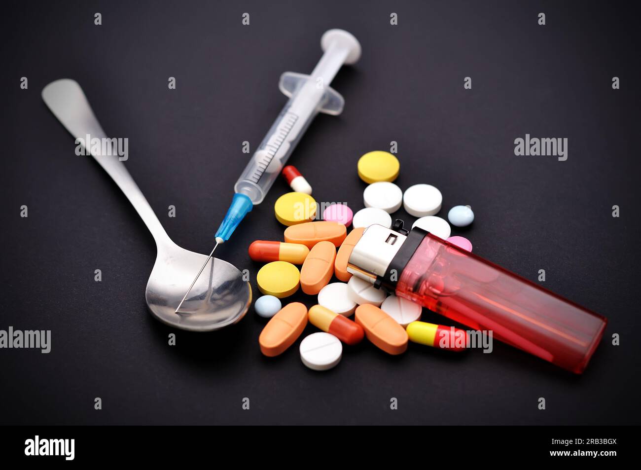 narcotic pills and syringe on black background Stock Photo - Alamy