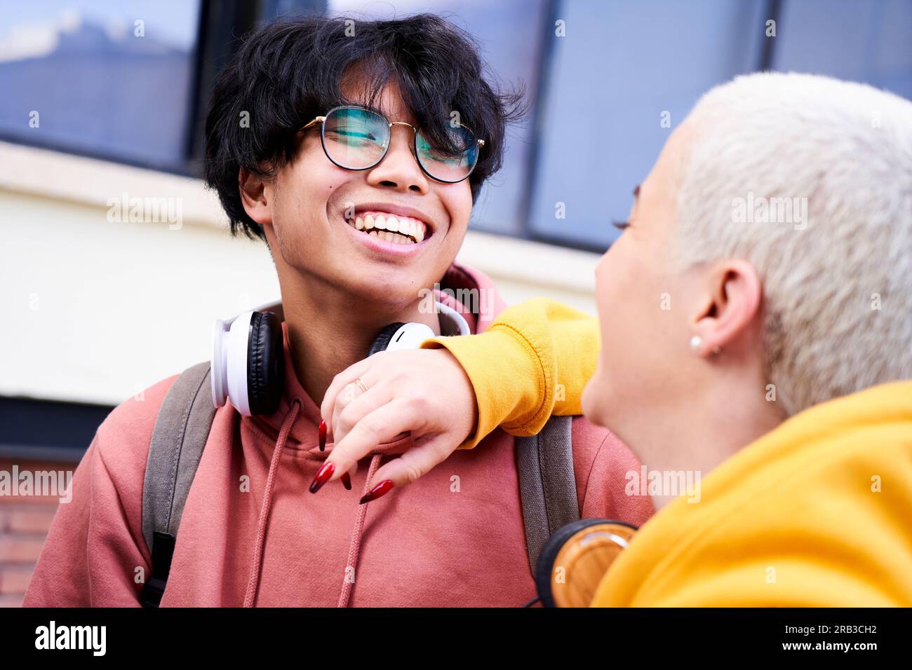 Group of two students laugh a lot and have fun outdoors. Teenage gen z ...