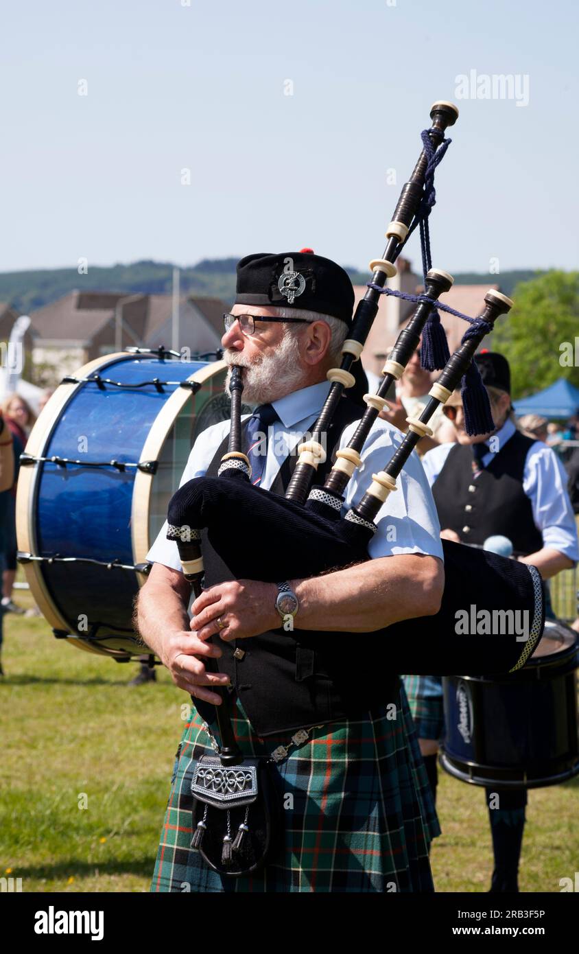 Piper playing the bagpipes with Helensburgh and Clan Colquhoun Pipe ...