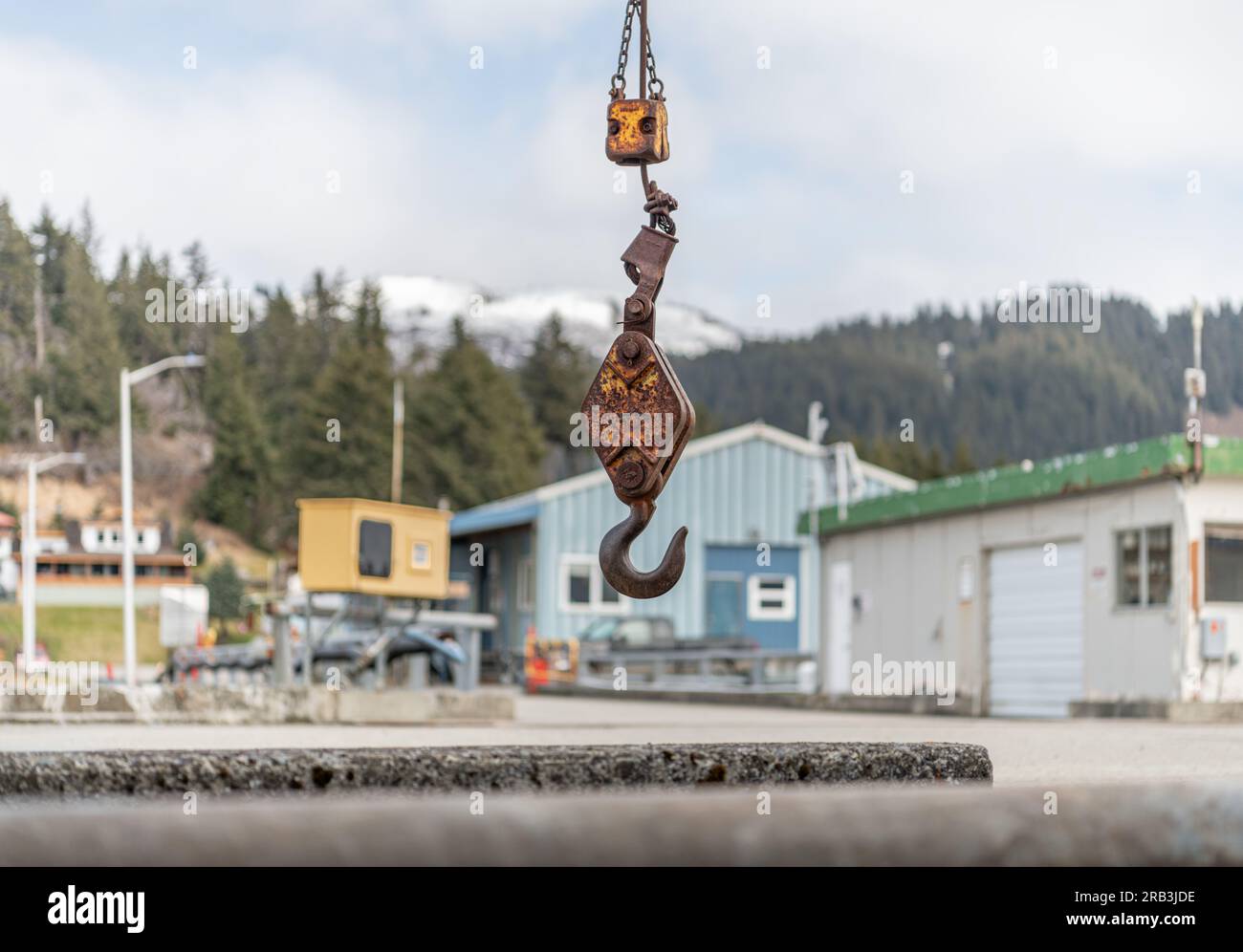 Crane hook on the Ferry Terminal Dock with the village of Seldovia out ...