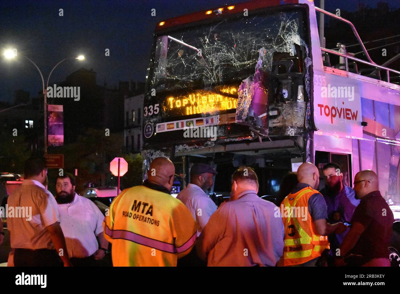 Investigators surround the double decker tour bus involved in the ...