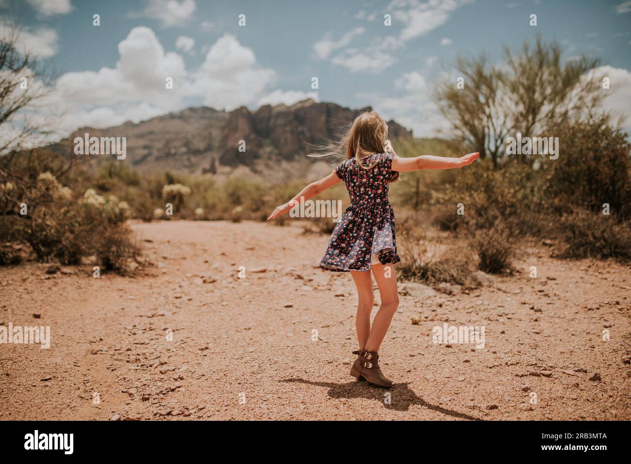 Girl twirling in the Arizona Desert sun Stock Photo - Alamy